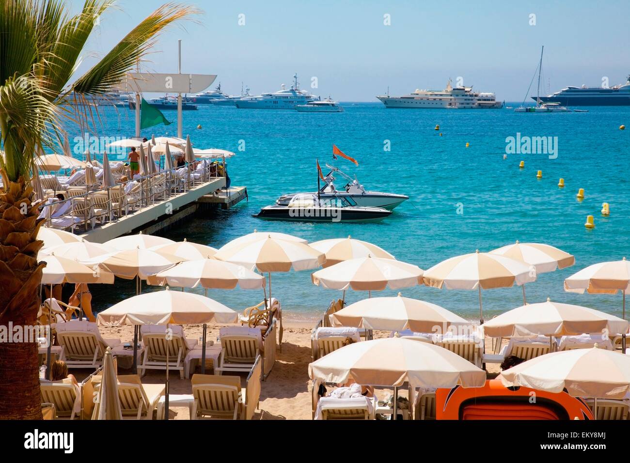 Cannes, Provence, France; Beach Umbrellas On The Shore And Boats In The ...