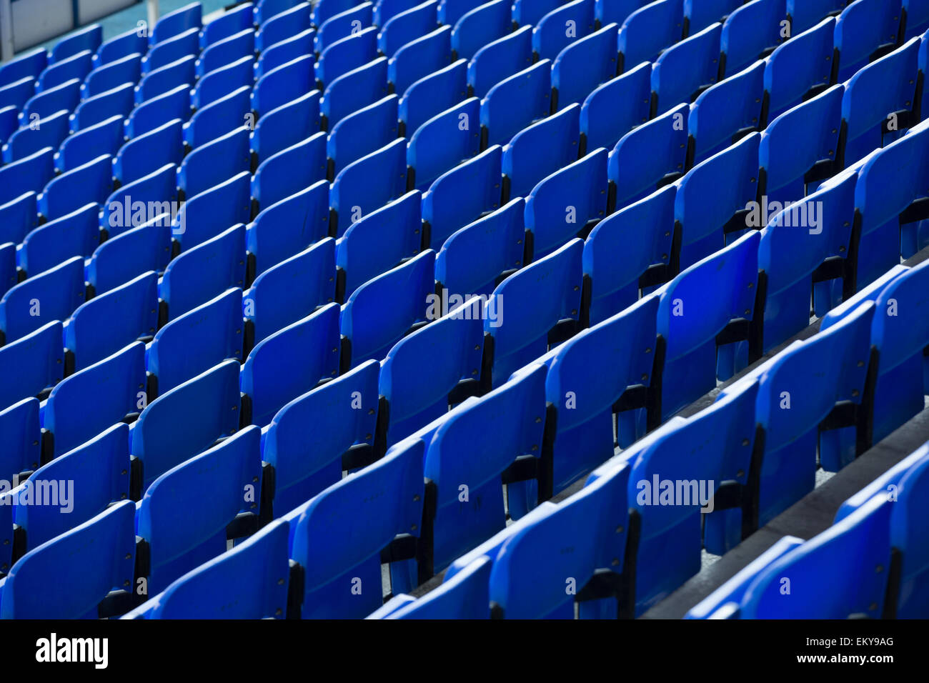 Blue seating in football stadium Stock Photo - Alamy