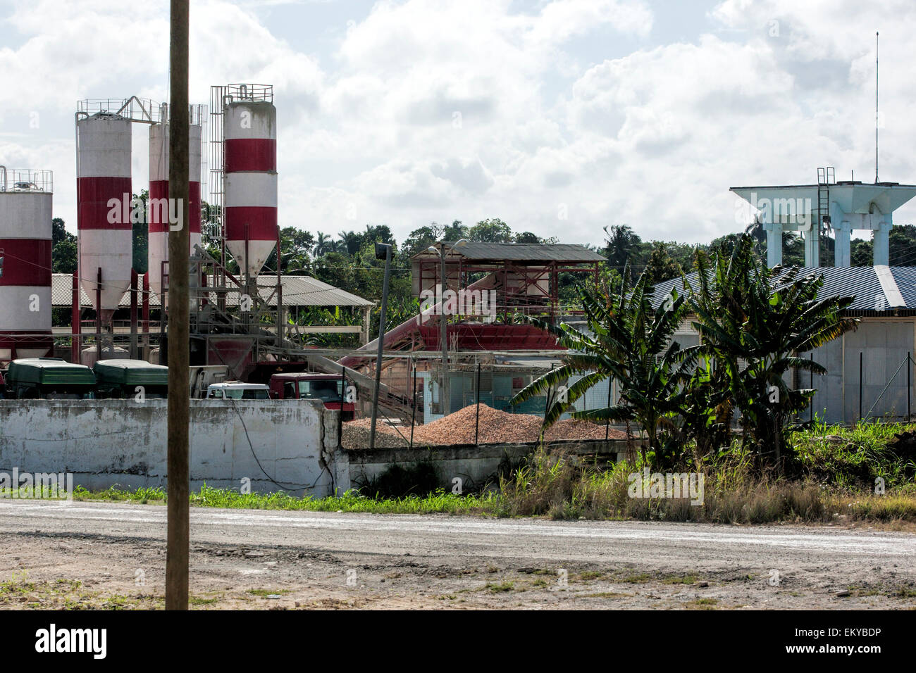 A derelict looking but working factory with red and white chimneys in a ...