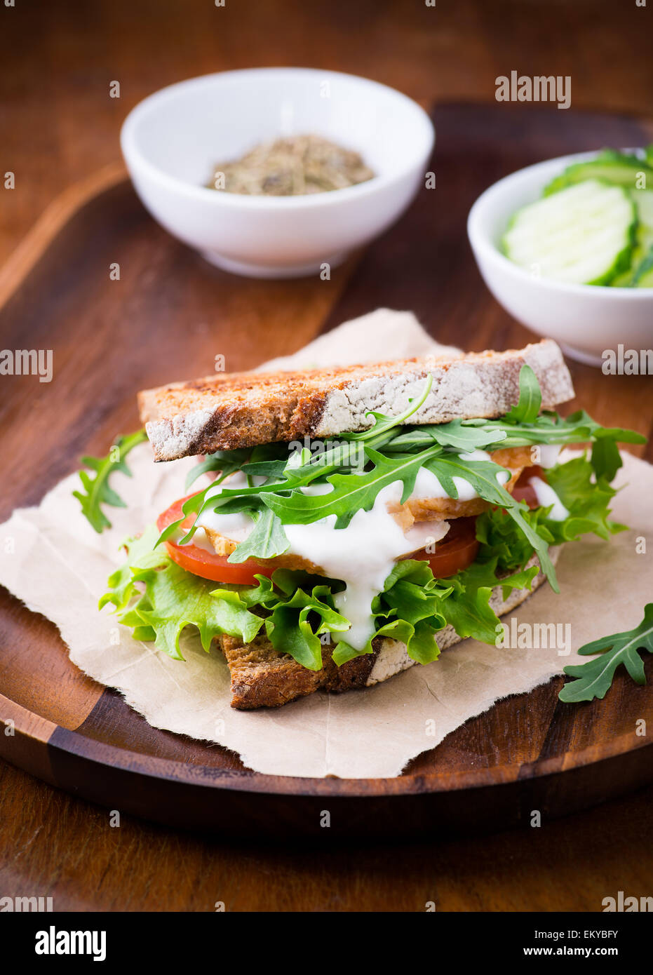 Rye toast sandwich with green leaf, tomato and chicken, selective focus ...