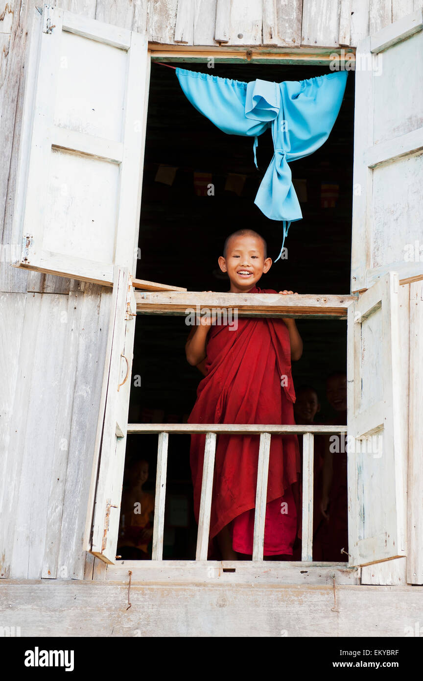 Burma, Shan State, Junior monk stands at a window looking out; Lashio ...