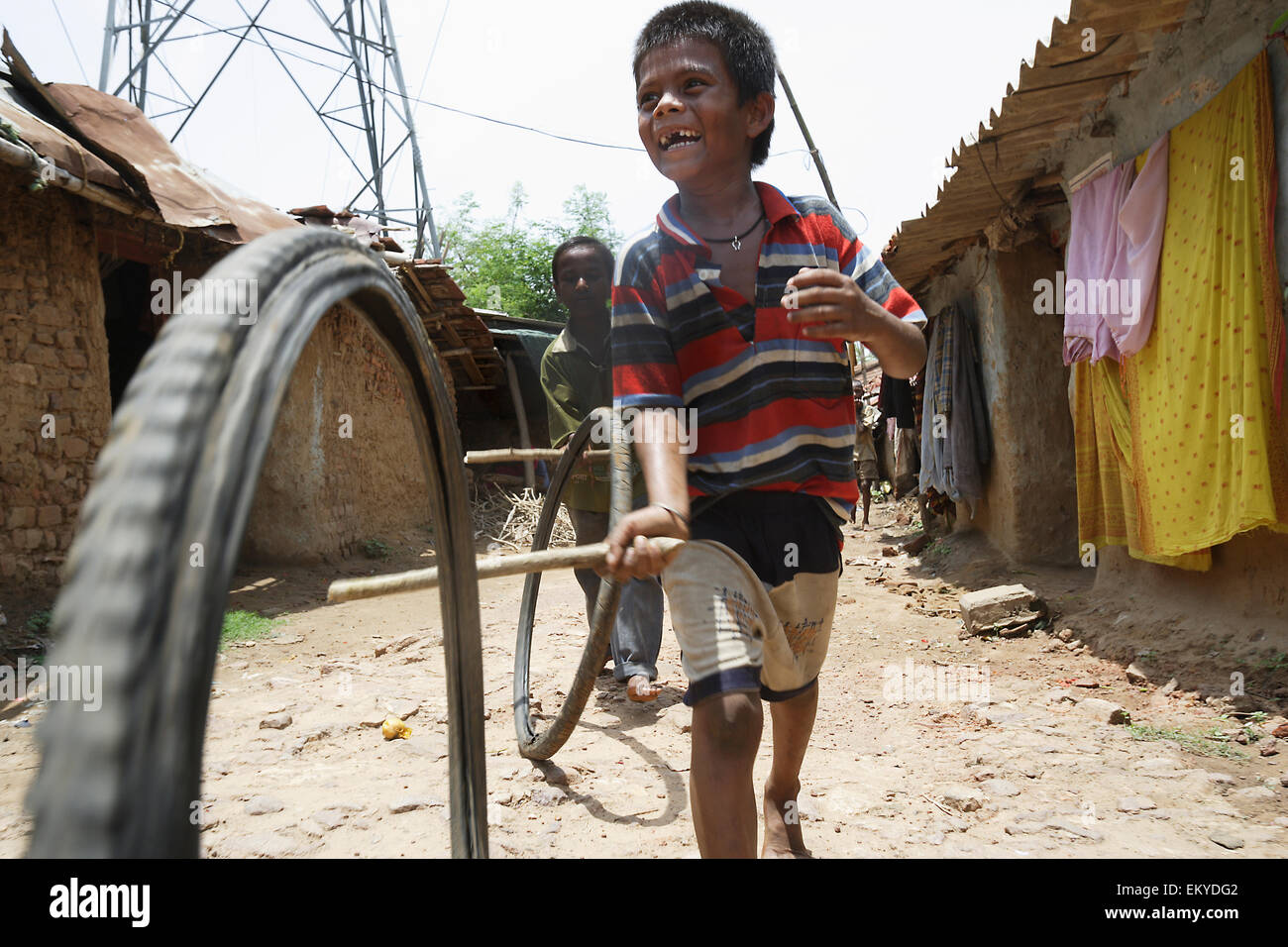 Young boys play with an old tire; India Stock Photo - Alamy