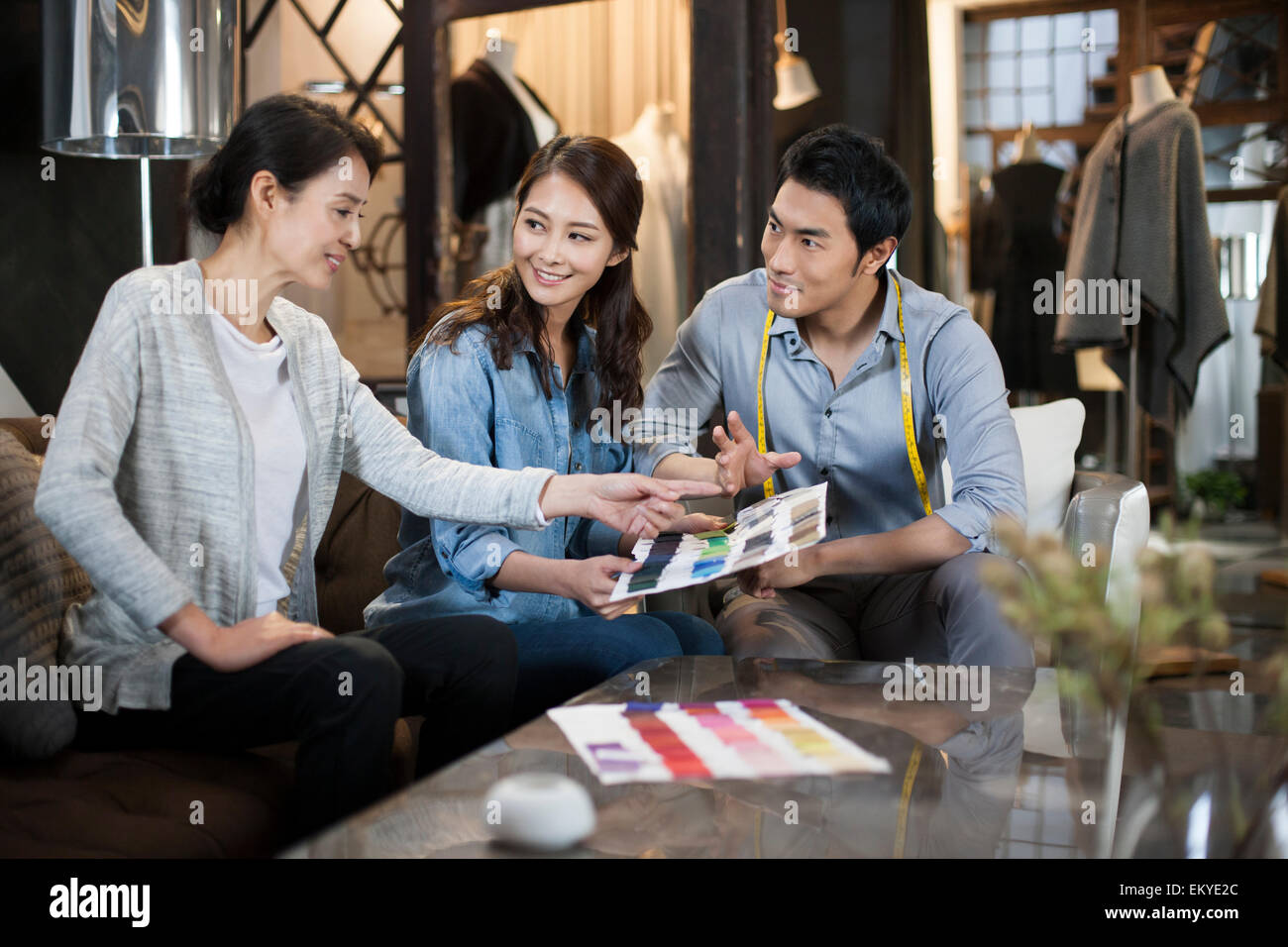 Fashion designers talking in studio Stock Photo - Alamy