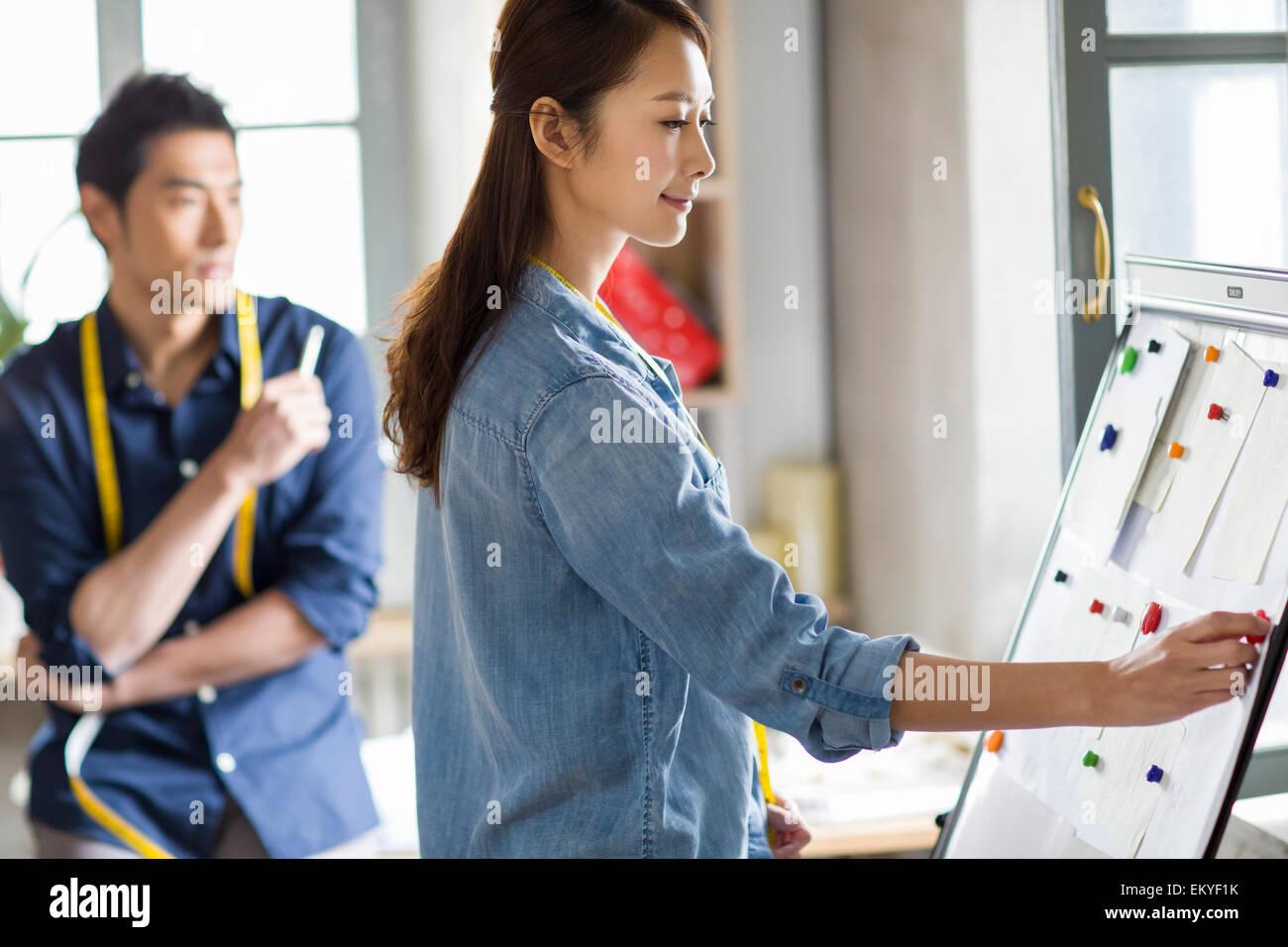 Two fashion designers working in studio Stock Photo - Alamy