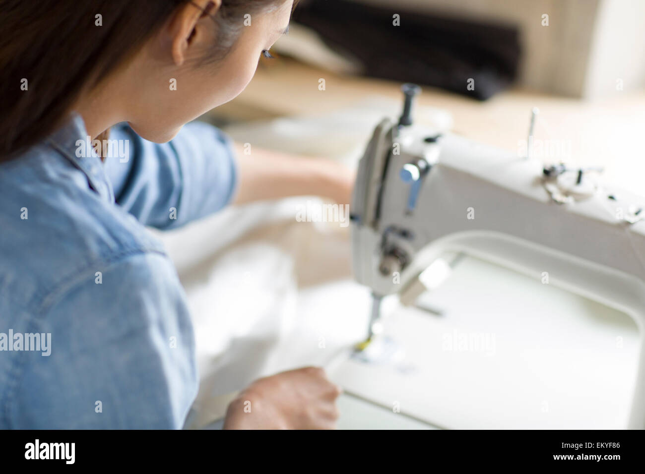 Fashion designer using sewing machine Stock Photo - Alamy
