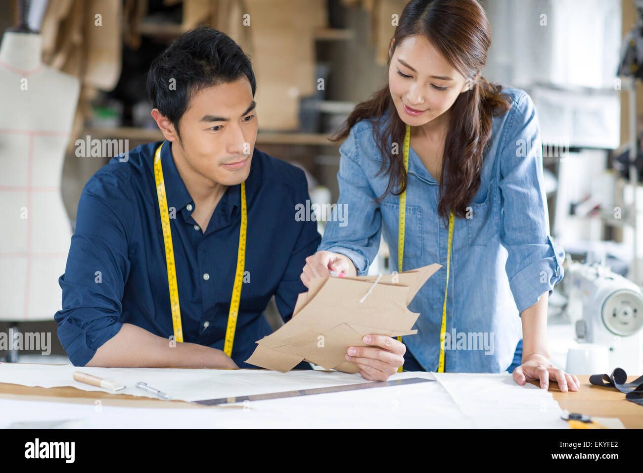 Two fashion designers working in studio Stock Photo - Alamy