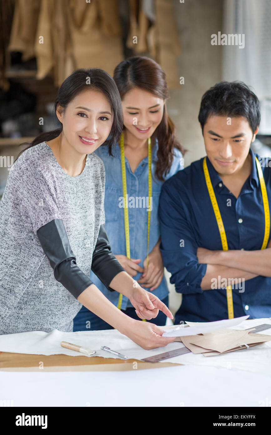 Fashion designers talking in studio Stock Photo - Alamy