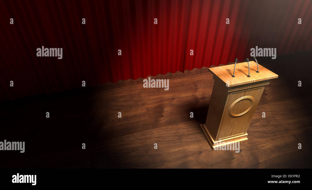 A regular theater stage with closed red curtains and a wooden debate ...