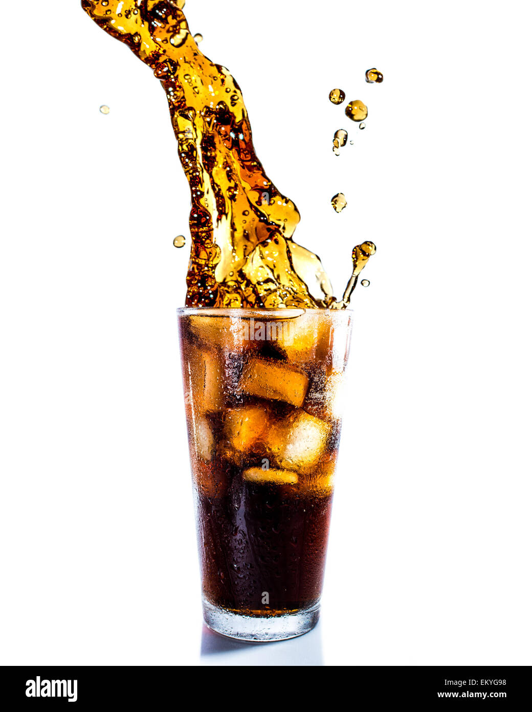 Cola drink splash with ice cube on white background Stock Photo - Alamy