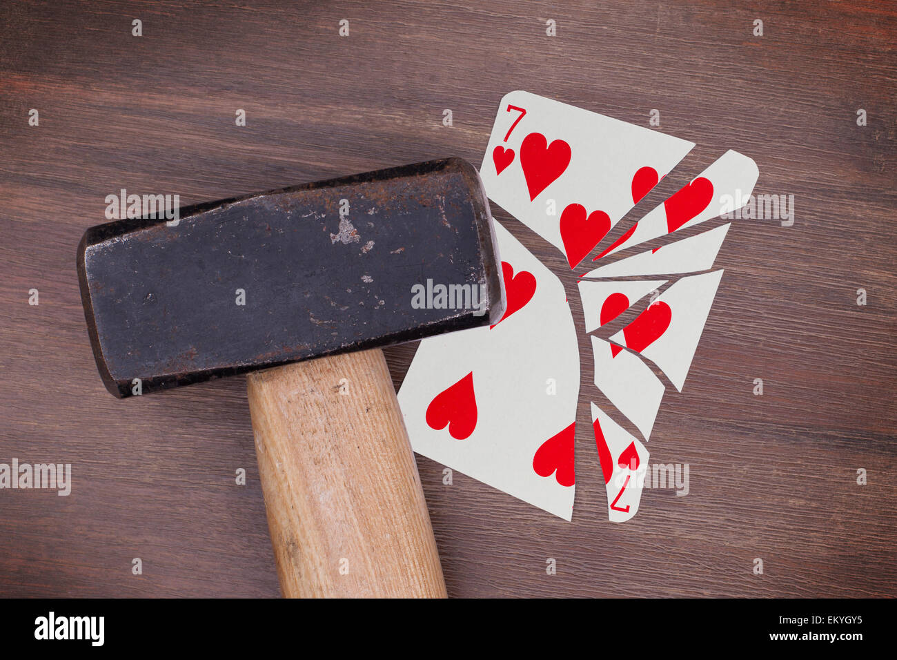 Hammer with a broken card, vintage look, seven of hearts Stock Photo ...