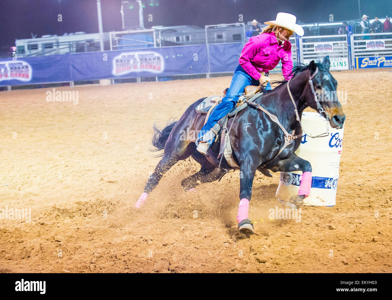 Cowgirl Participating in a Barrel racing competition in the Clark ...