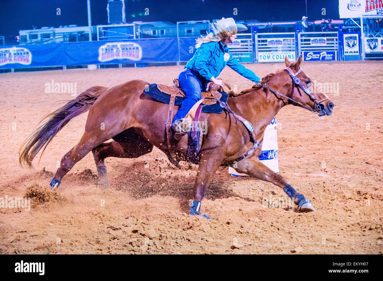 Cowgirl Participating in a Barrel racing competition in the Clark ...