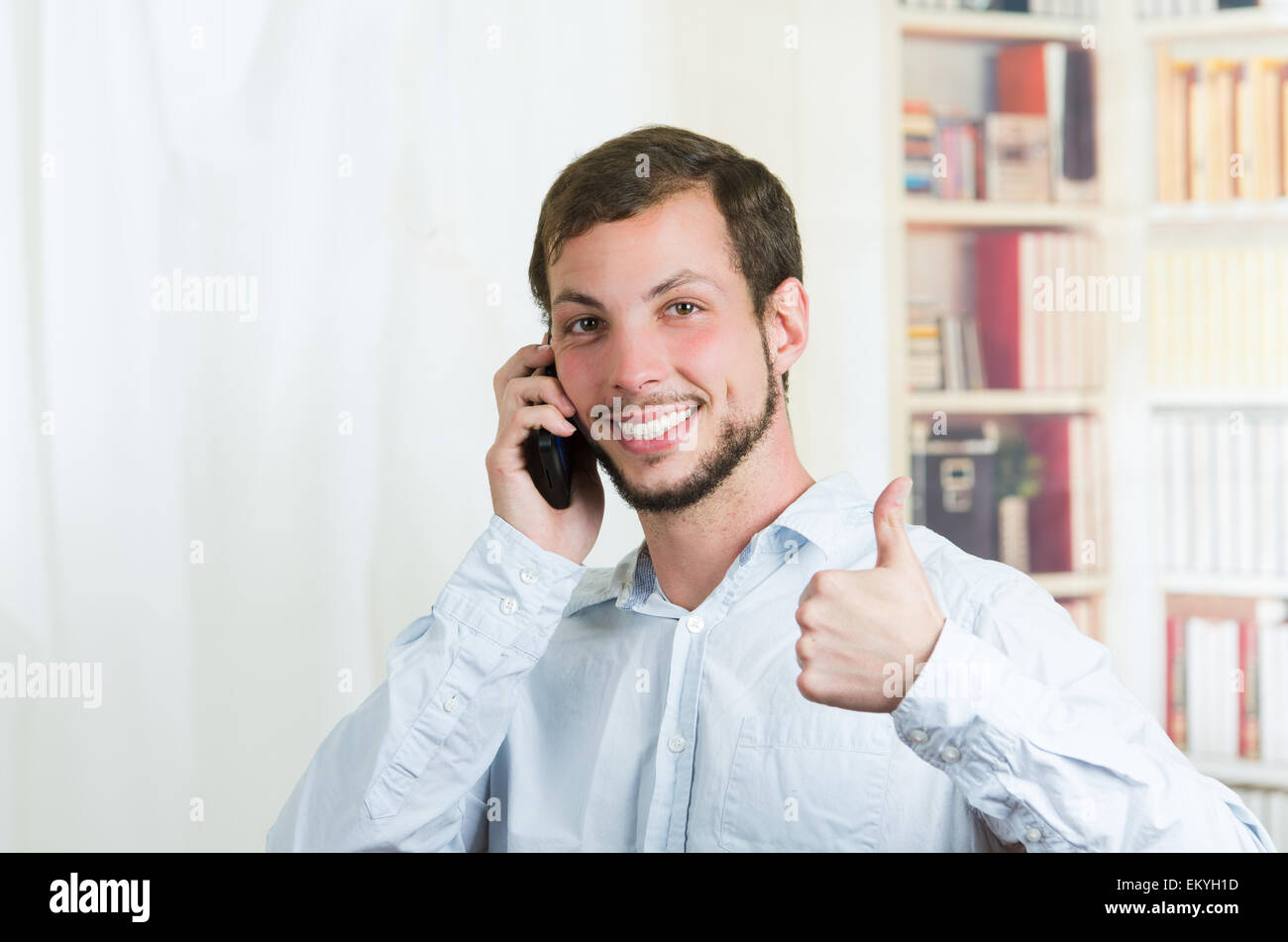 young handsome man using cell phone Stock Photo - Alamy