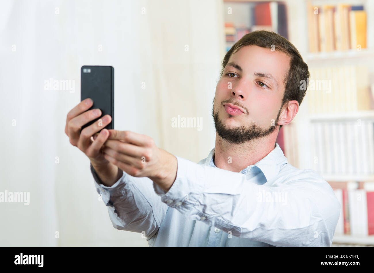 attractive young man using cell phone to take a selfie Stock Photo - Alamy