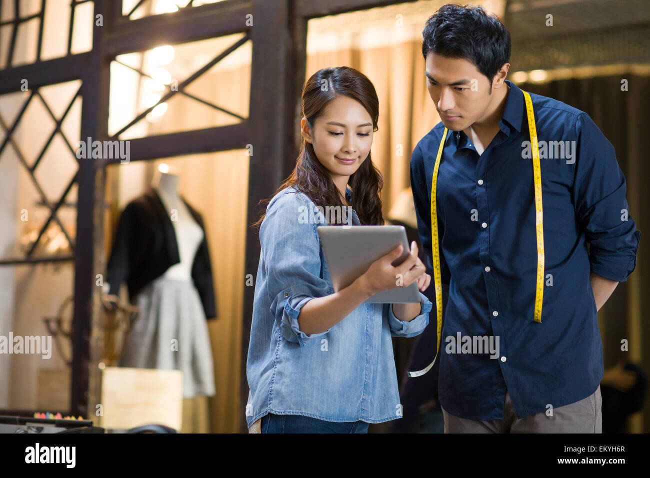 Two fashion designers using tablet studio hi-res stock photography and ...