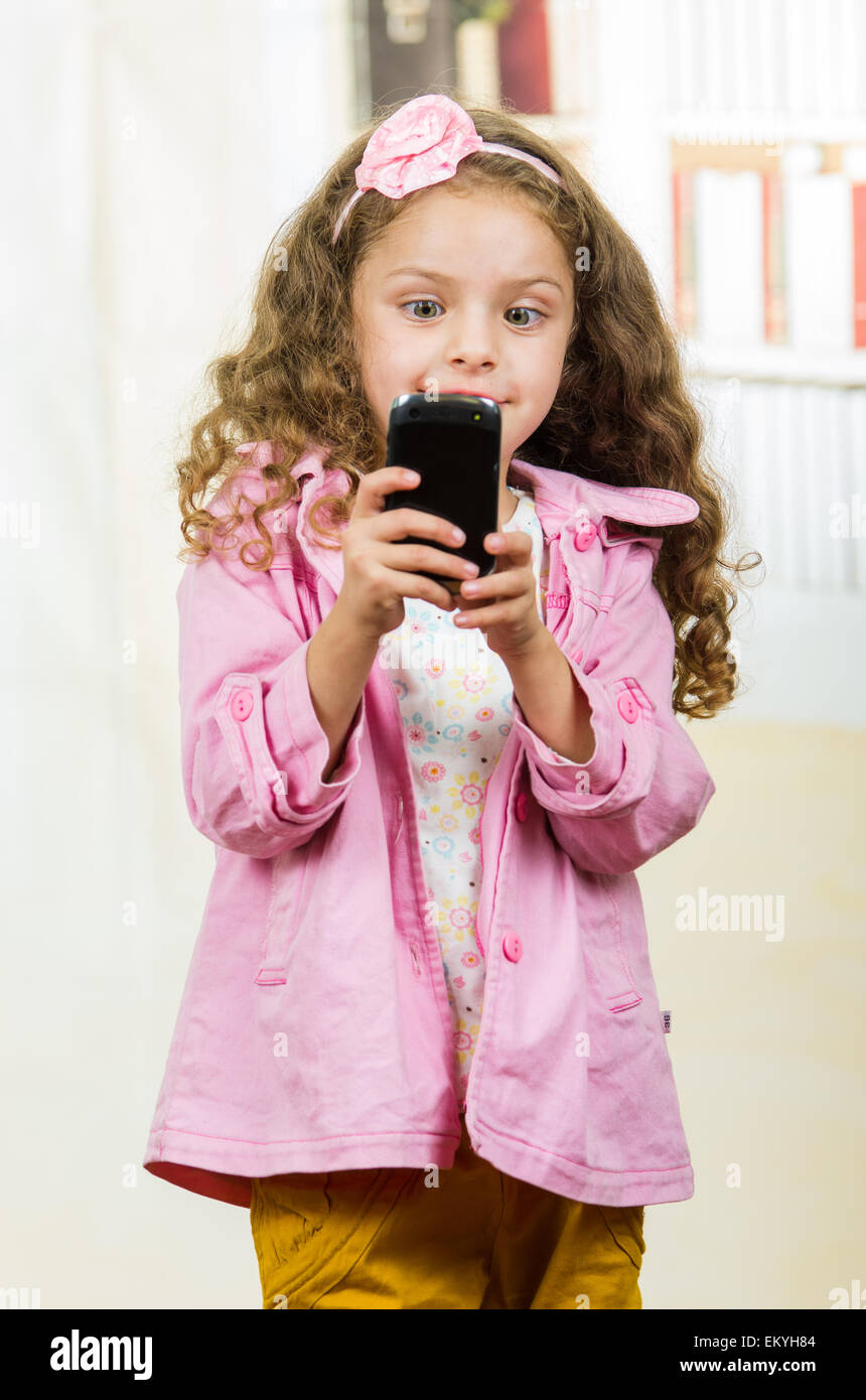 cute little girl using cell phone Stock Photo - Alamy