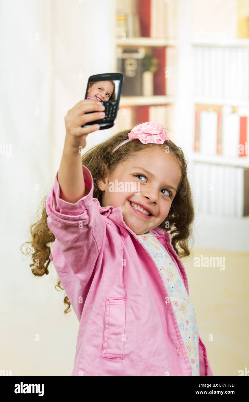 cute little girl using cell phone taking a selfie Stock Photo - Alamy