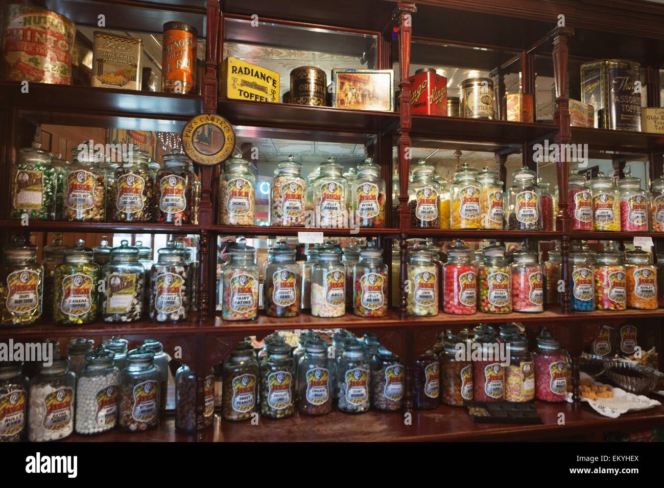 A Variety Of Candies On Display In Glass Jars On Shelves; Beamish ...