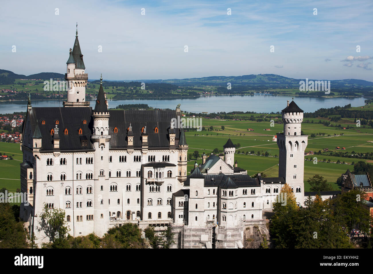 A Large Bavarian Castle With Fields, Lake And Village In The Background ...