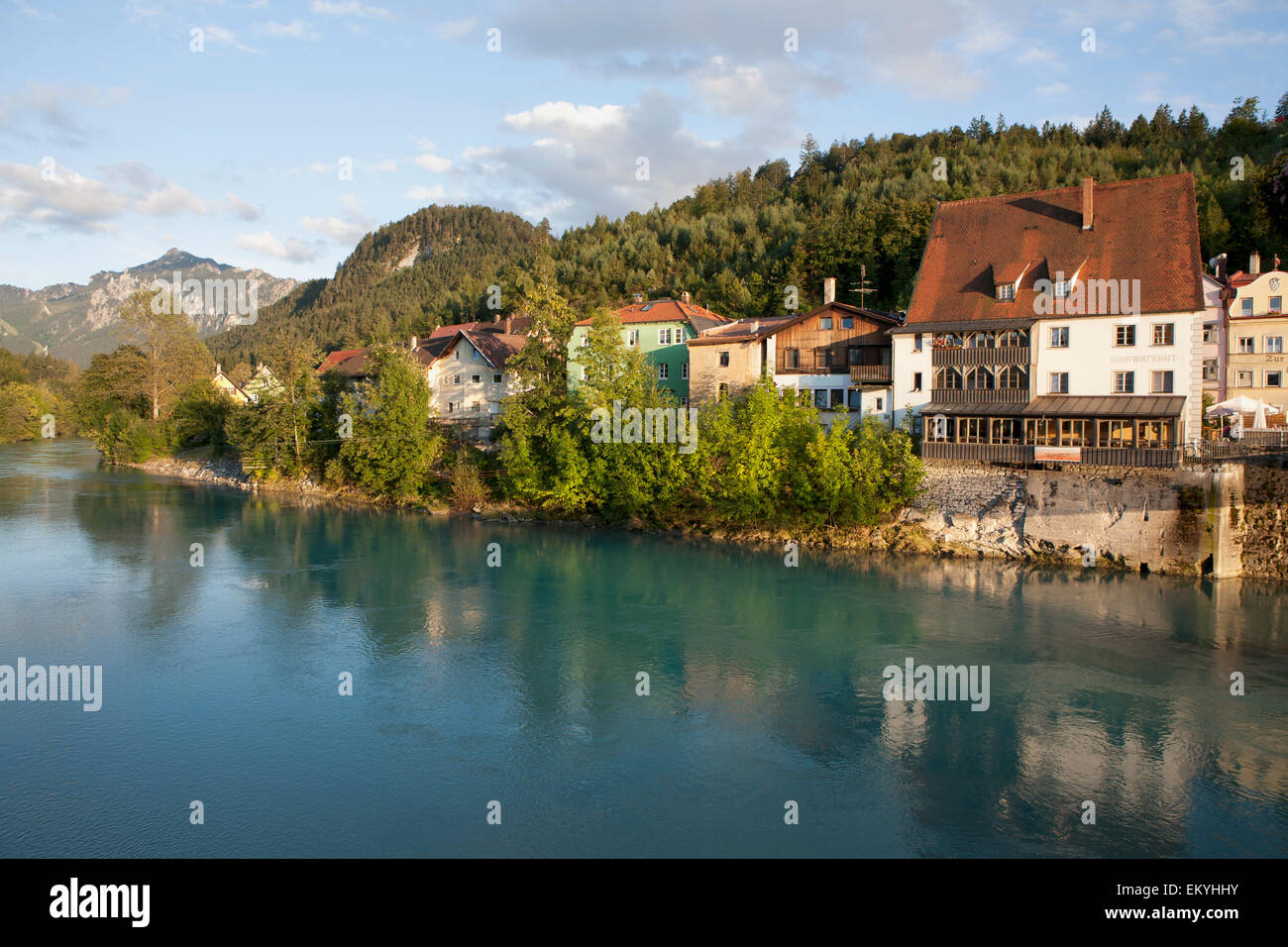Bavarian Style Houses Reflecting On A River With Mountains In The ...