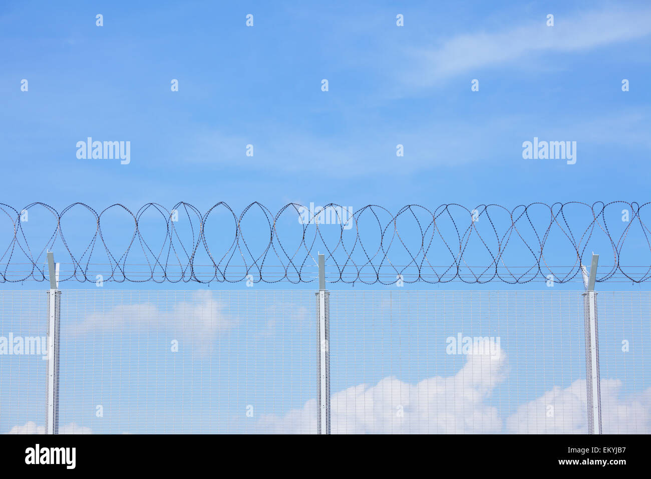Chain link fence with barbed wire Stock Photo - Alamy