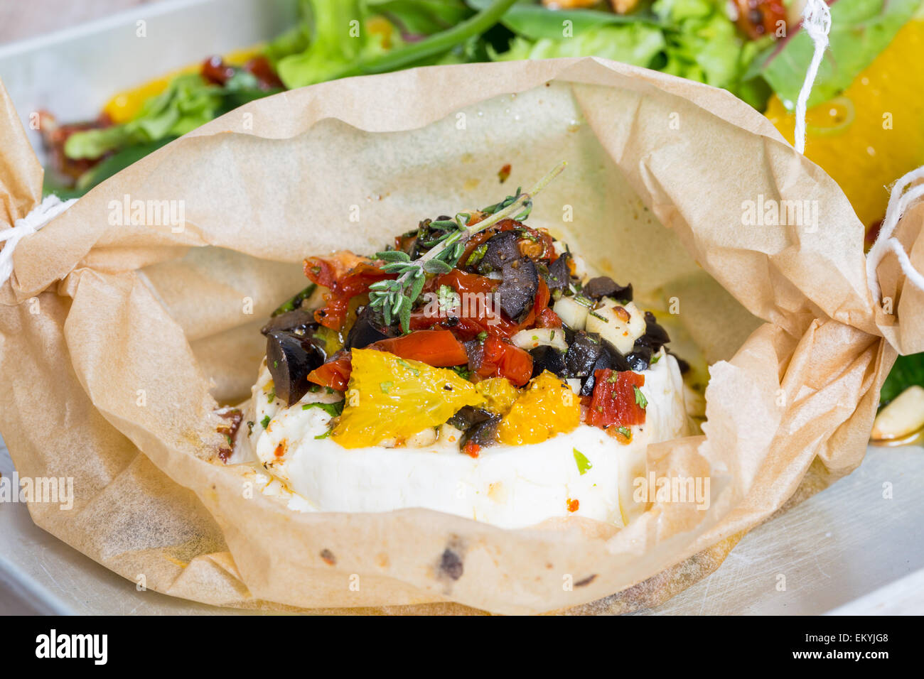 Baked goat cheese Mediterranean in parchment paper Stock Photo - Alamy
