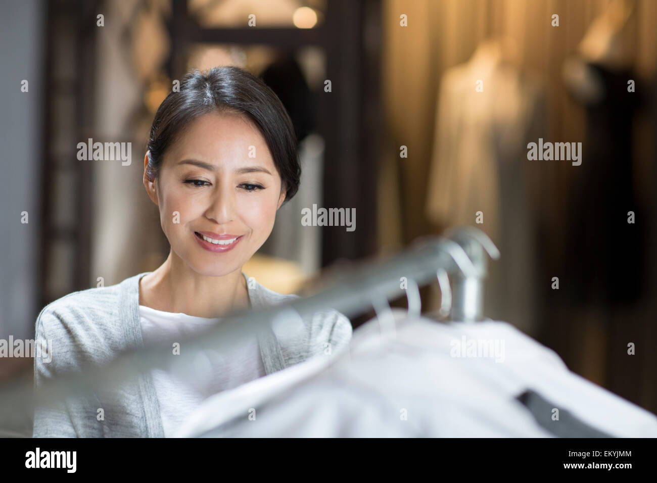 Clothing store owner checking clothes Stock Photo - Alamy