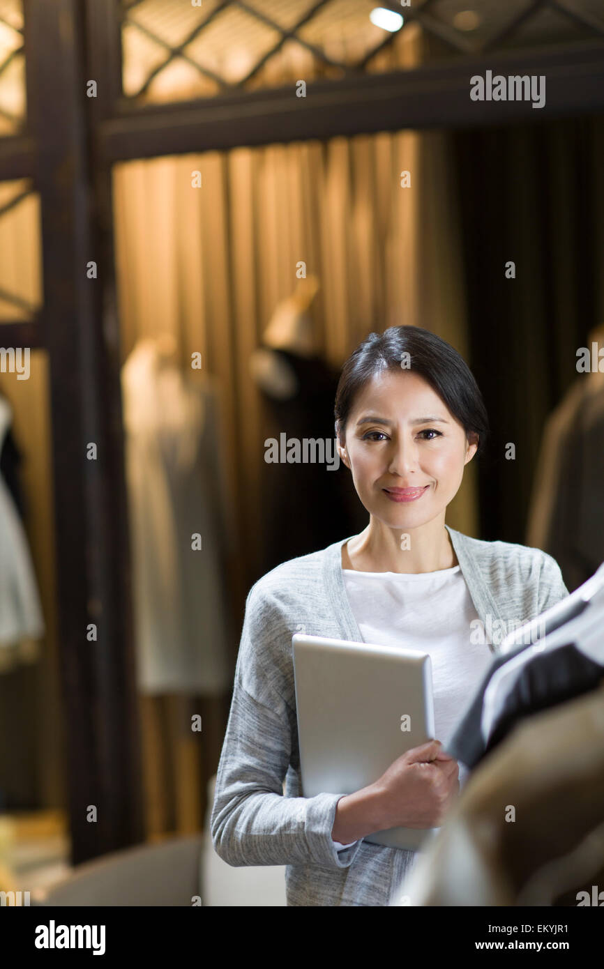 Clothing store owner with digital tablet Stock Photo - Alamy