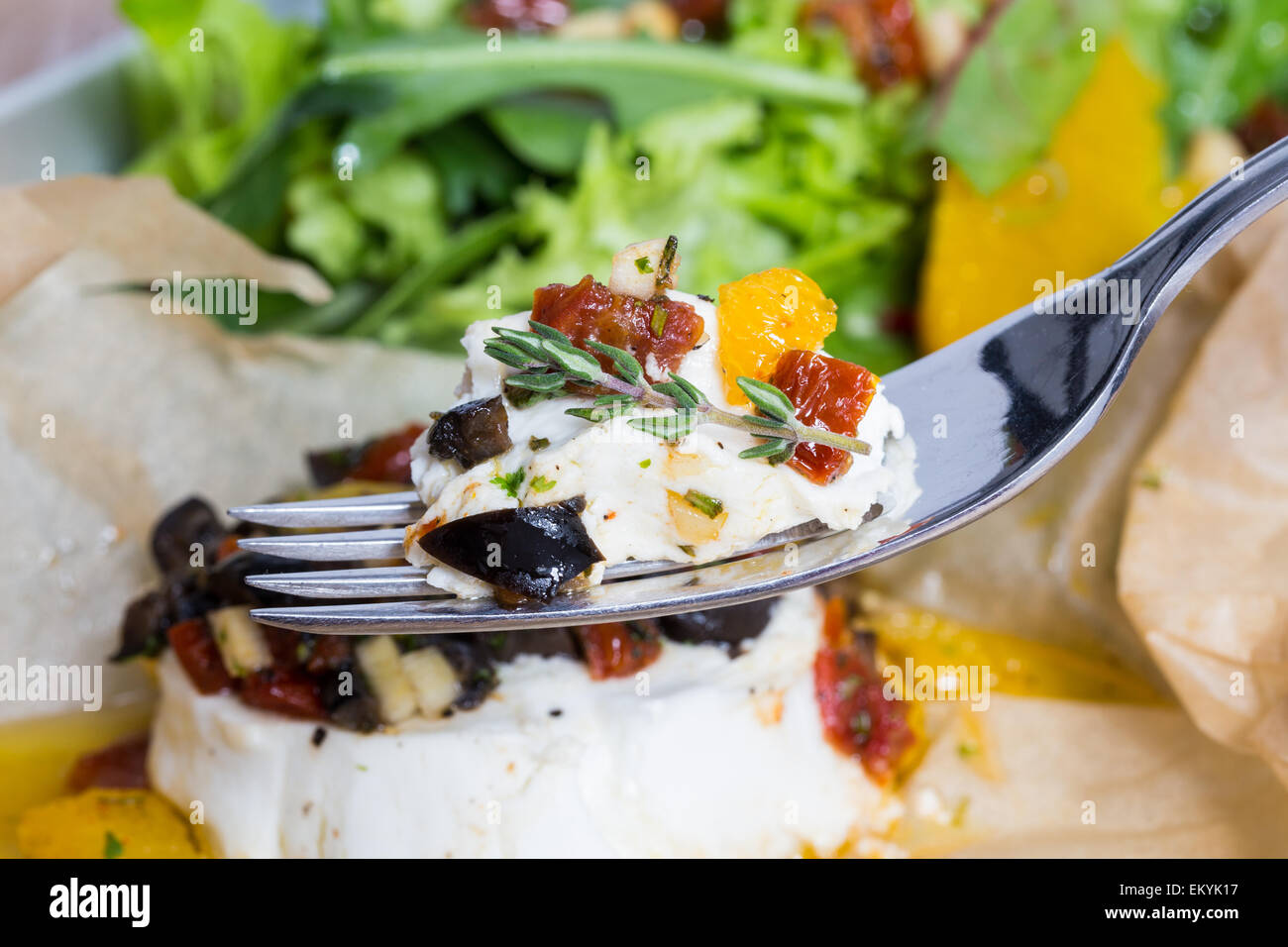 Baked goat cheese Mediterranean in parchment paper Stock Photo - Alamy
