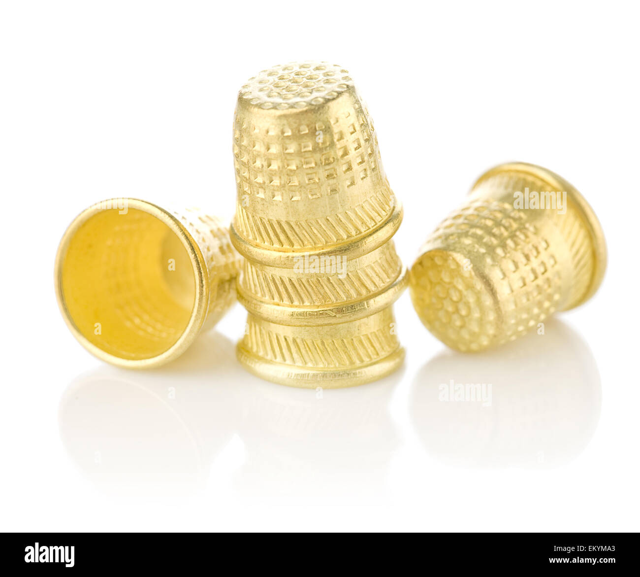 five golden timbles isolated on white background Stock Photo - Alamy