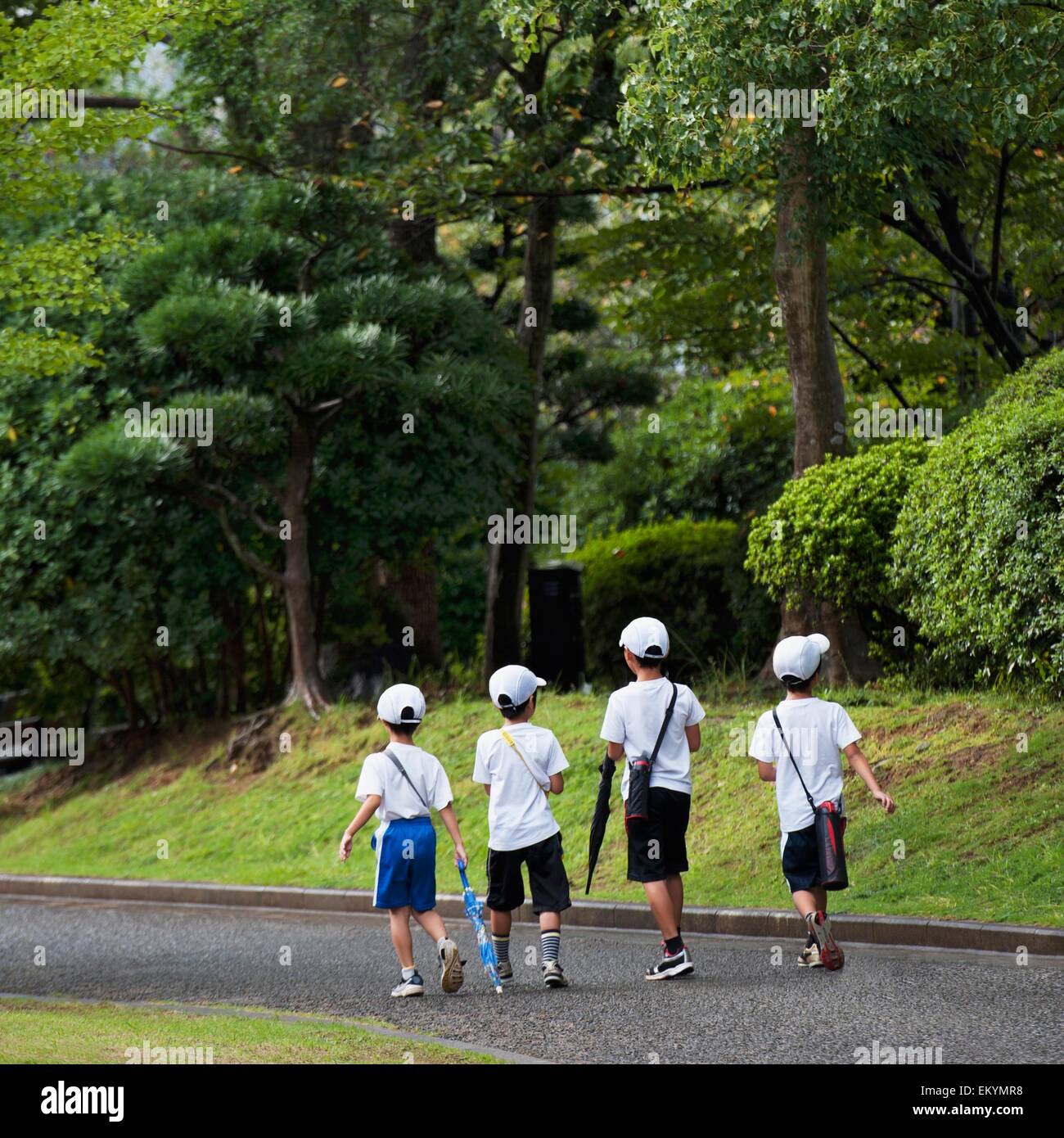 Four Boys Walking Down A Path In The Peace Park; Nagasaki, Japan Stock ...
