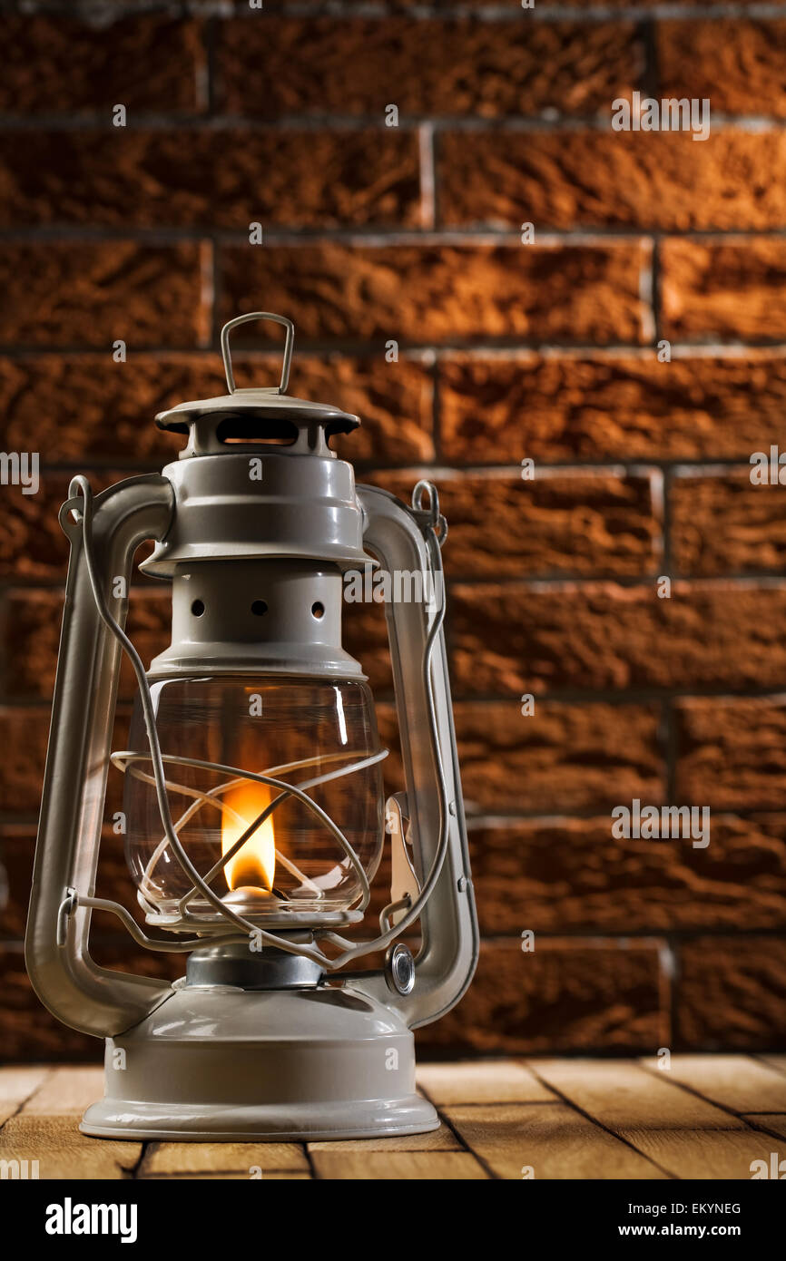 kerosene lamp on brick background Stock Photo - Alamy