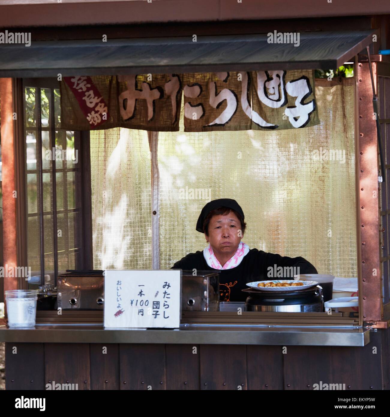 A Woman Selling Food Behind A Counter At The Todaiji Temple; Nara ...
