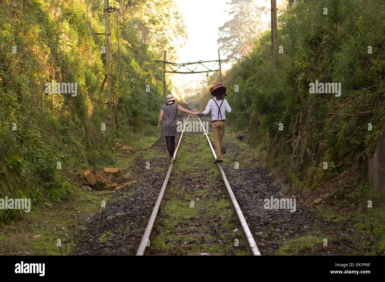 Retro young love couple vintage train tracks Stock Photo - Alamy