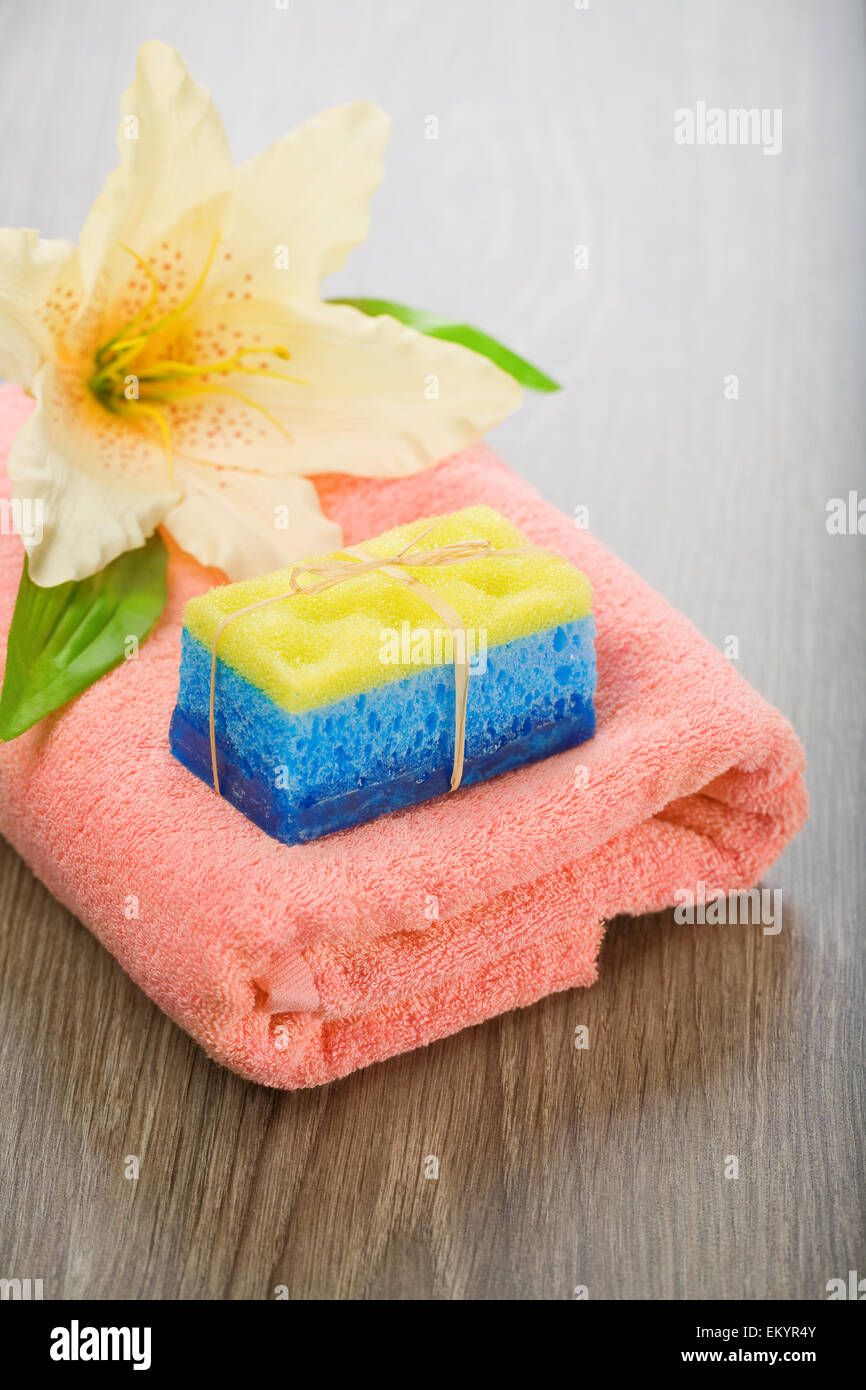 bath sponge soap and flower on towel Stock Photo - Alamy