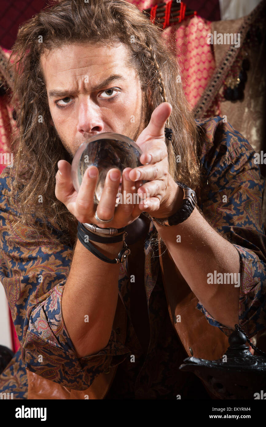 Man Looking into Crystal Ball Stock Photo - Alamy
