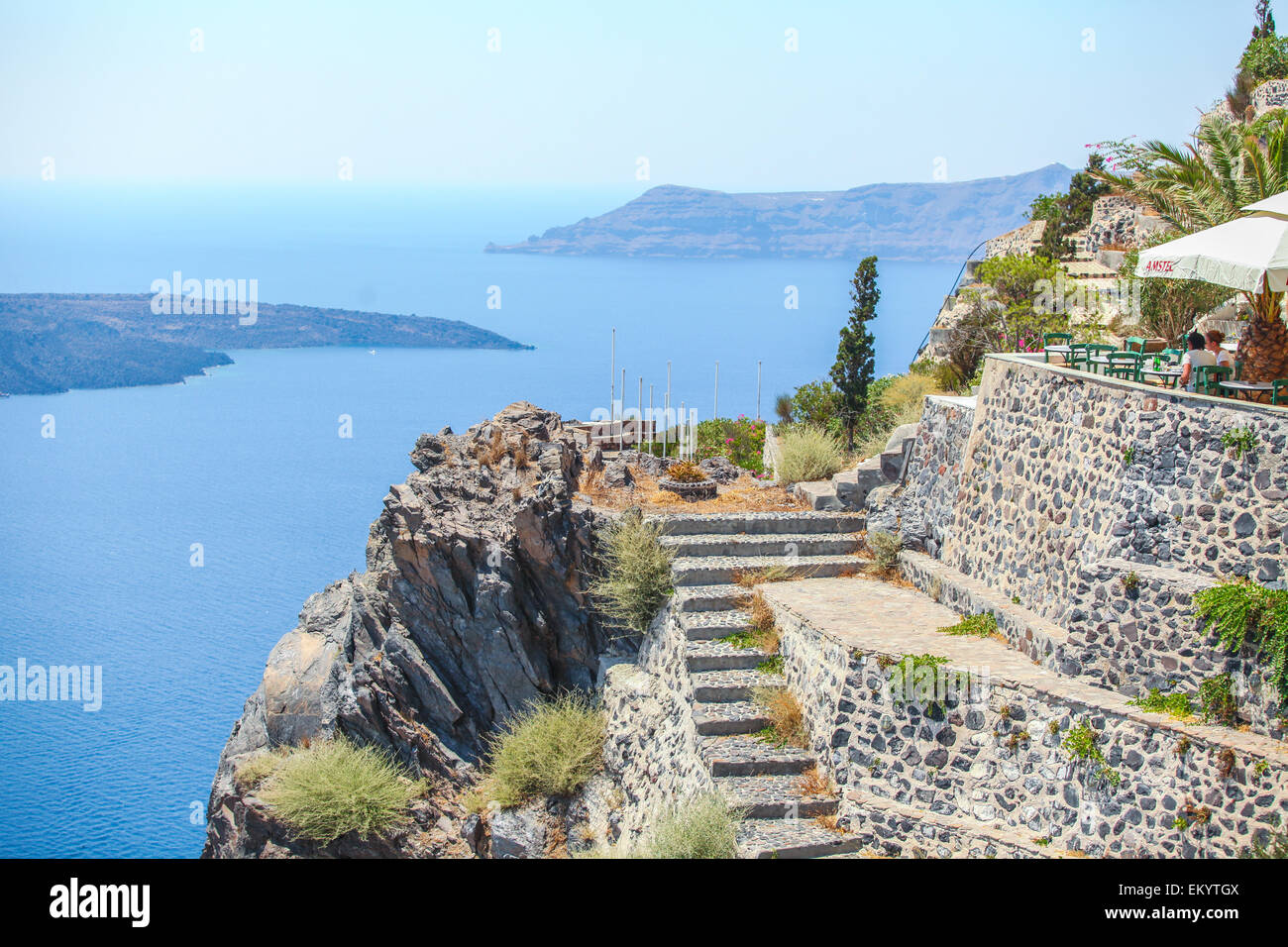 Traditional sights of colorful ladder and caldera sea in background ...