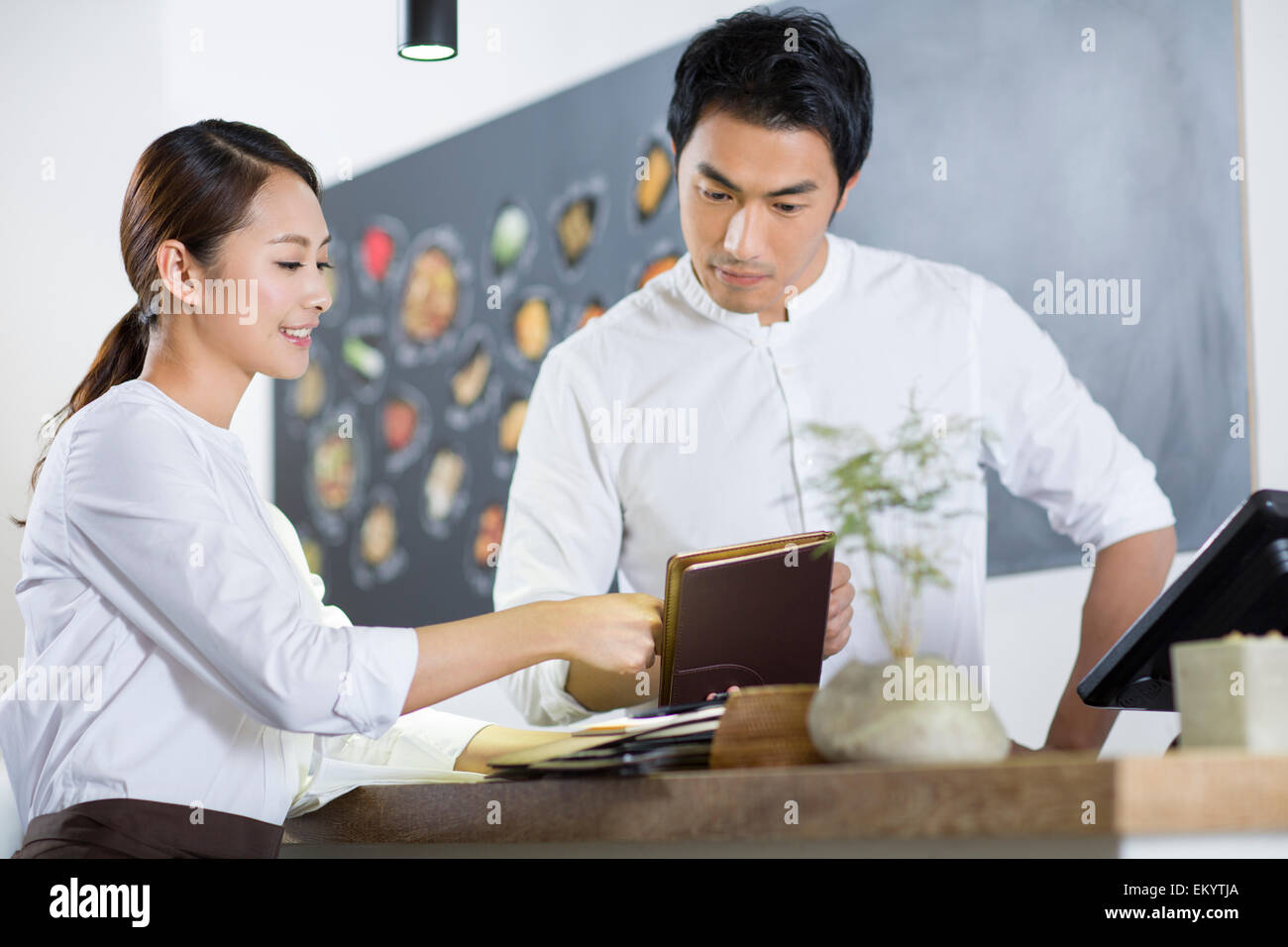 Young waitress and cashier Stock Photo - Alamy
