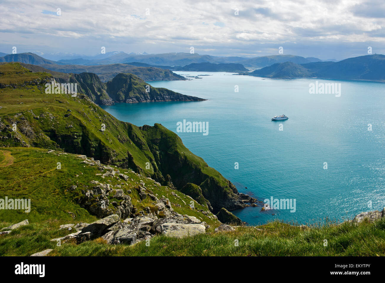 Cruise ship in a bay off the rugged cliffs of Runde island, Norway ...
