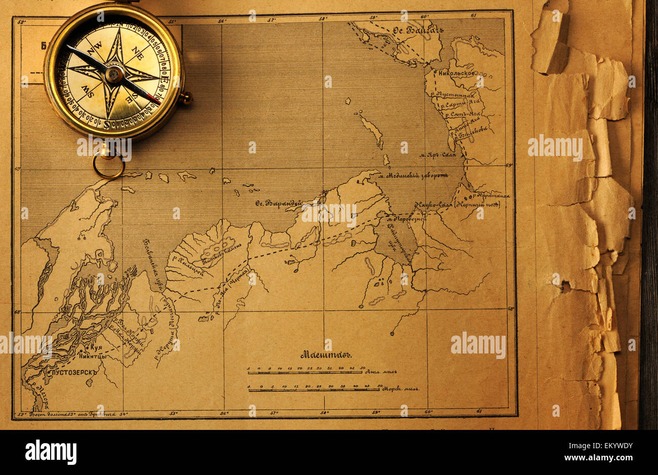 Antique compass over old map Stock Photo - Alamy
