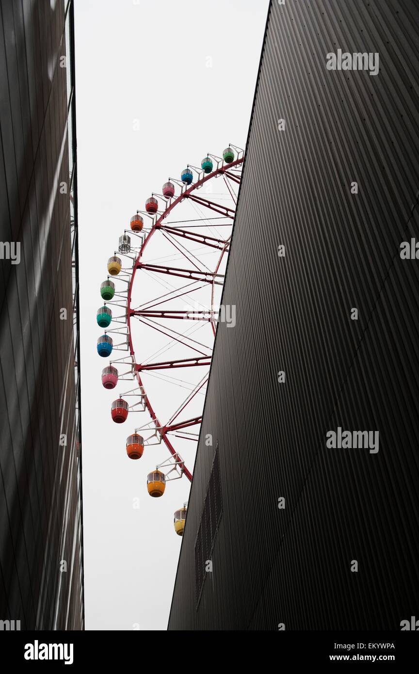 View Of A Ferris Wheel Beside A Tall Building; Tokyo, Japan Stock Photo ...