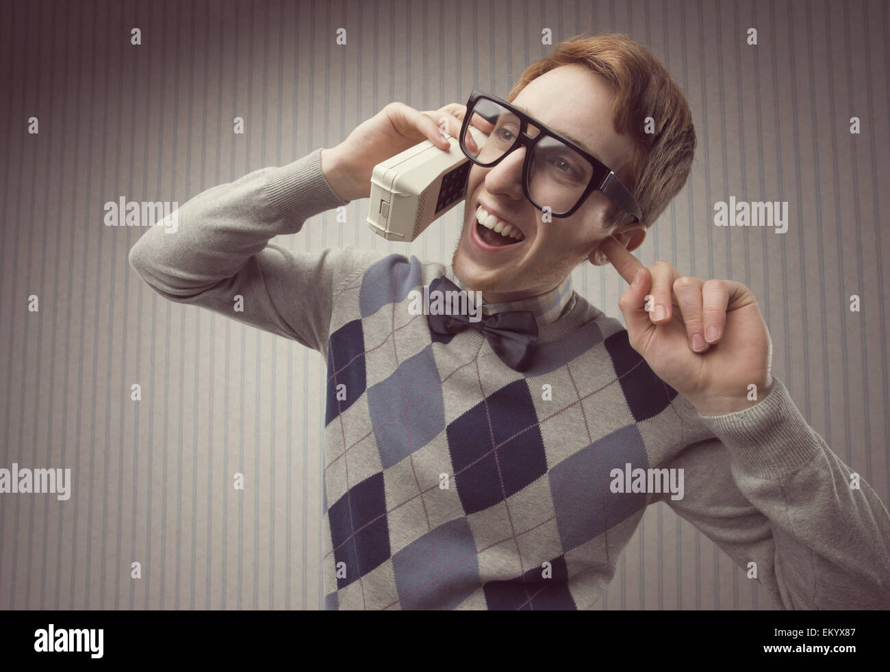 Nerd student with an old mobile phone Stock Photo - Alamy