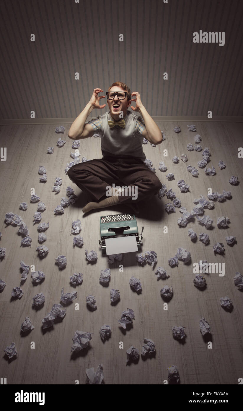 Frustrated man at typewriter Stock Photo - Alamy