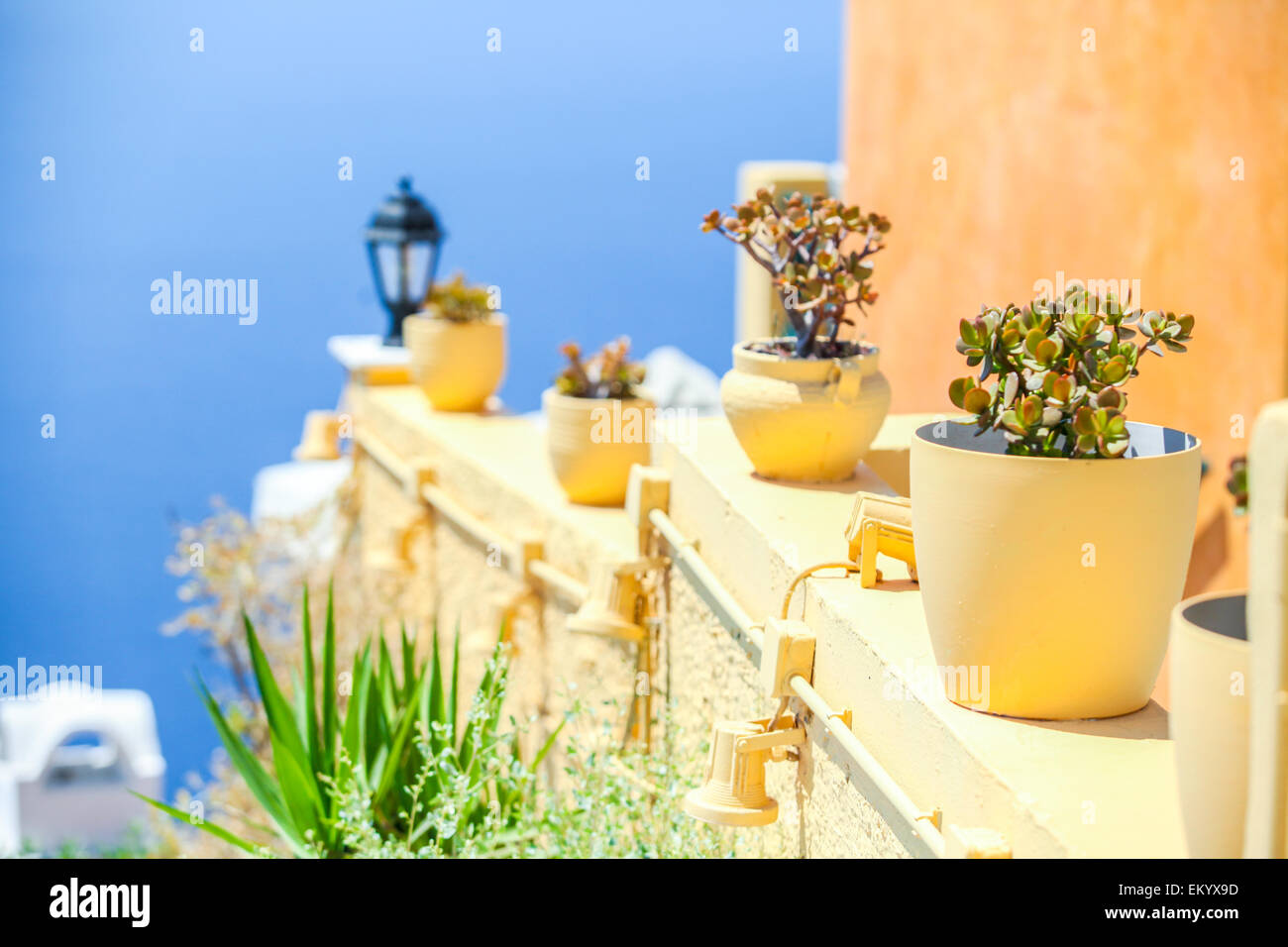 Traditional greek details: colorful flowers with pots, lantern and ...