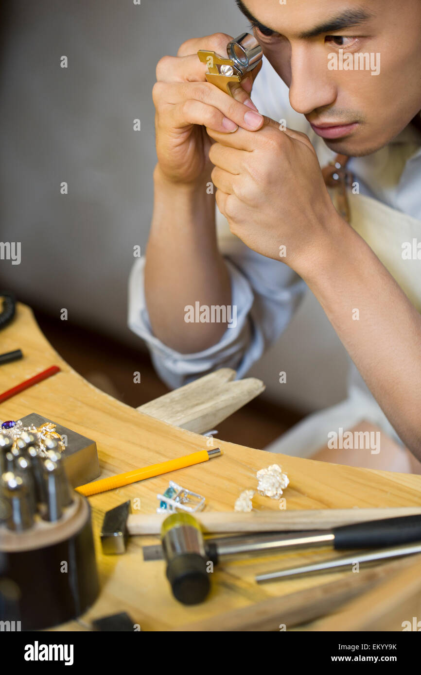 Male jeweler examining a diamond with loupe Stock Photo - Alamy