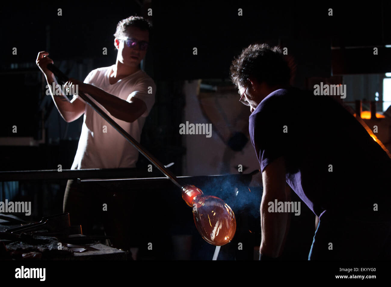 Making Glass in Dark Studio Stock Photo - Alamy