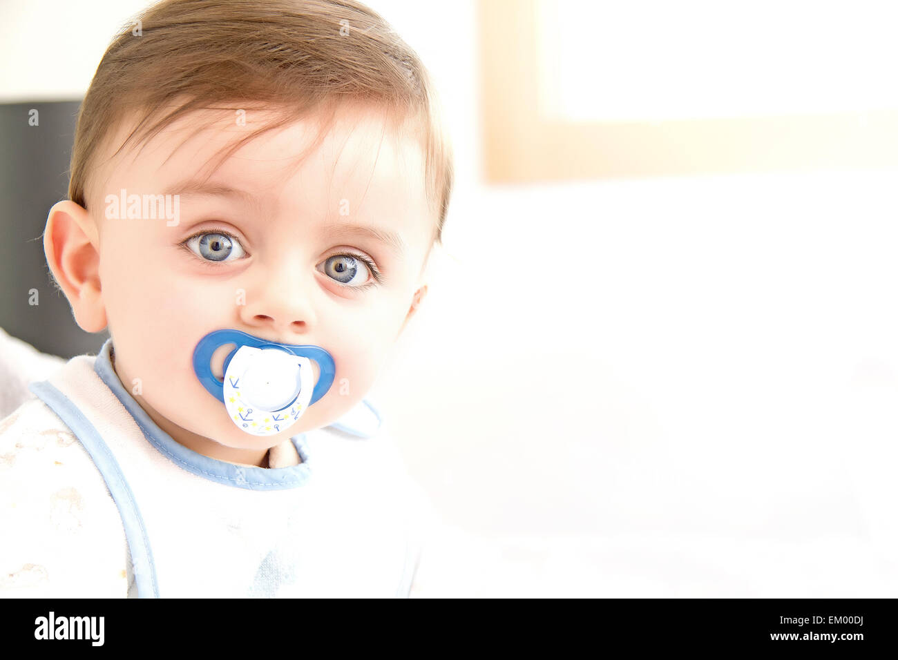 Baby with pacifier Stock Photo - Alamy