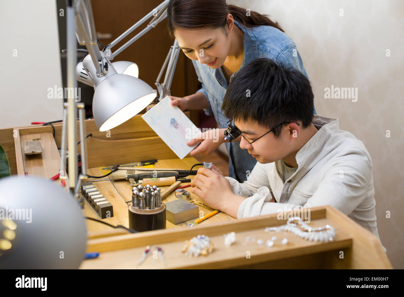 Jewelers making a sapphire ring Stock Photo - Alamy