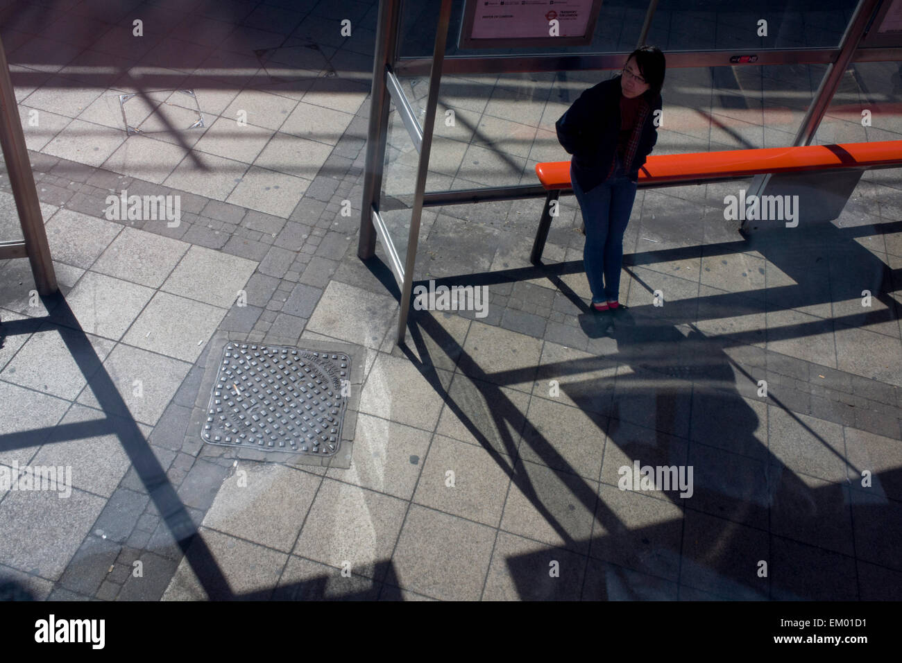 London bus passenger waits at a Waterloo bus stop Stock Photo - Alamy
