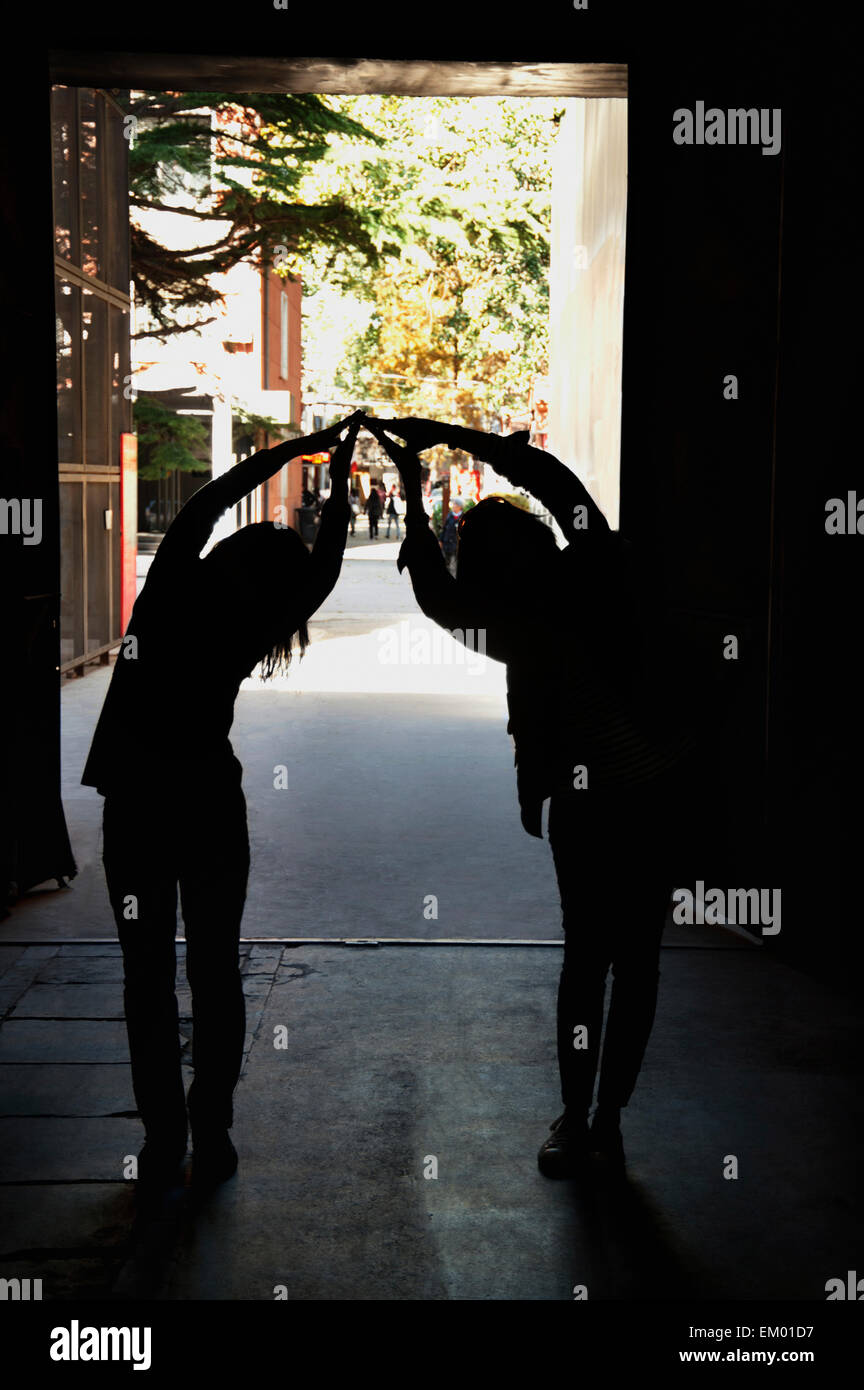 Two People Forming A Bridge With Their Hands; Beijing, China Stock ...